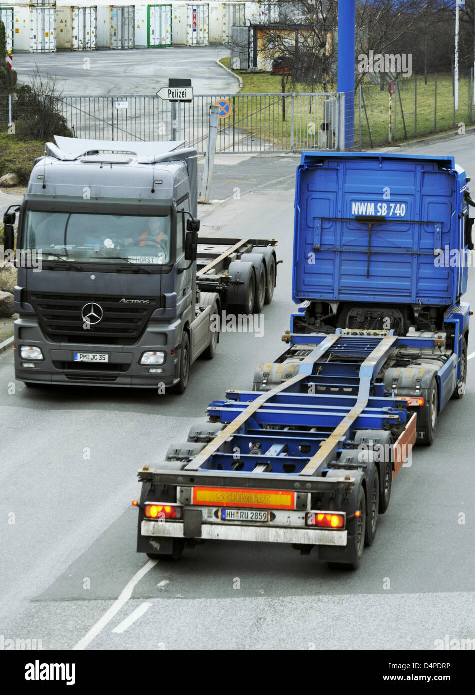 Two empty container lorries pass each other at Burchard pier in the ...
