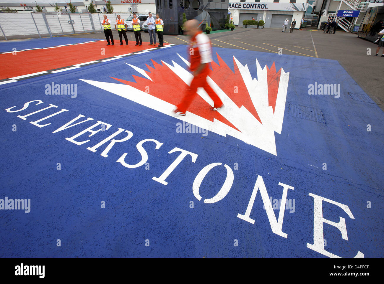 A man walks over a Silverstone logo at the Silverstone race track in ...