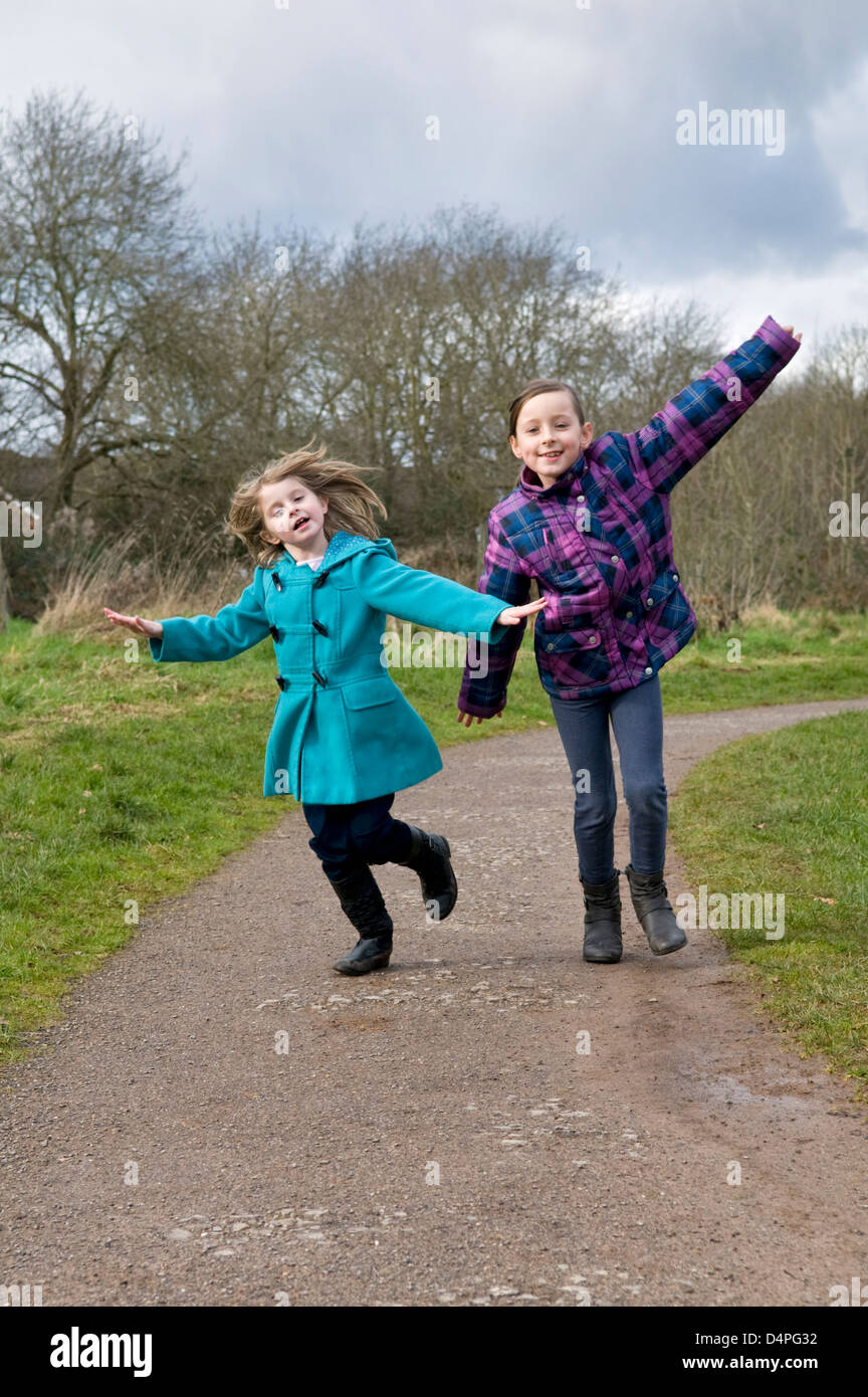 Children running making aeroplane (or airplane) shapes and having fun ...