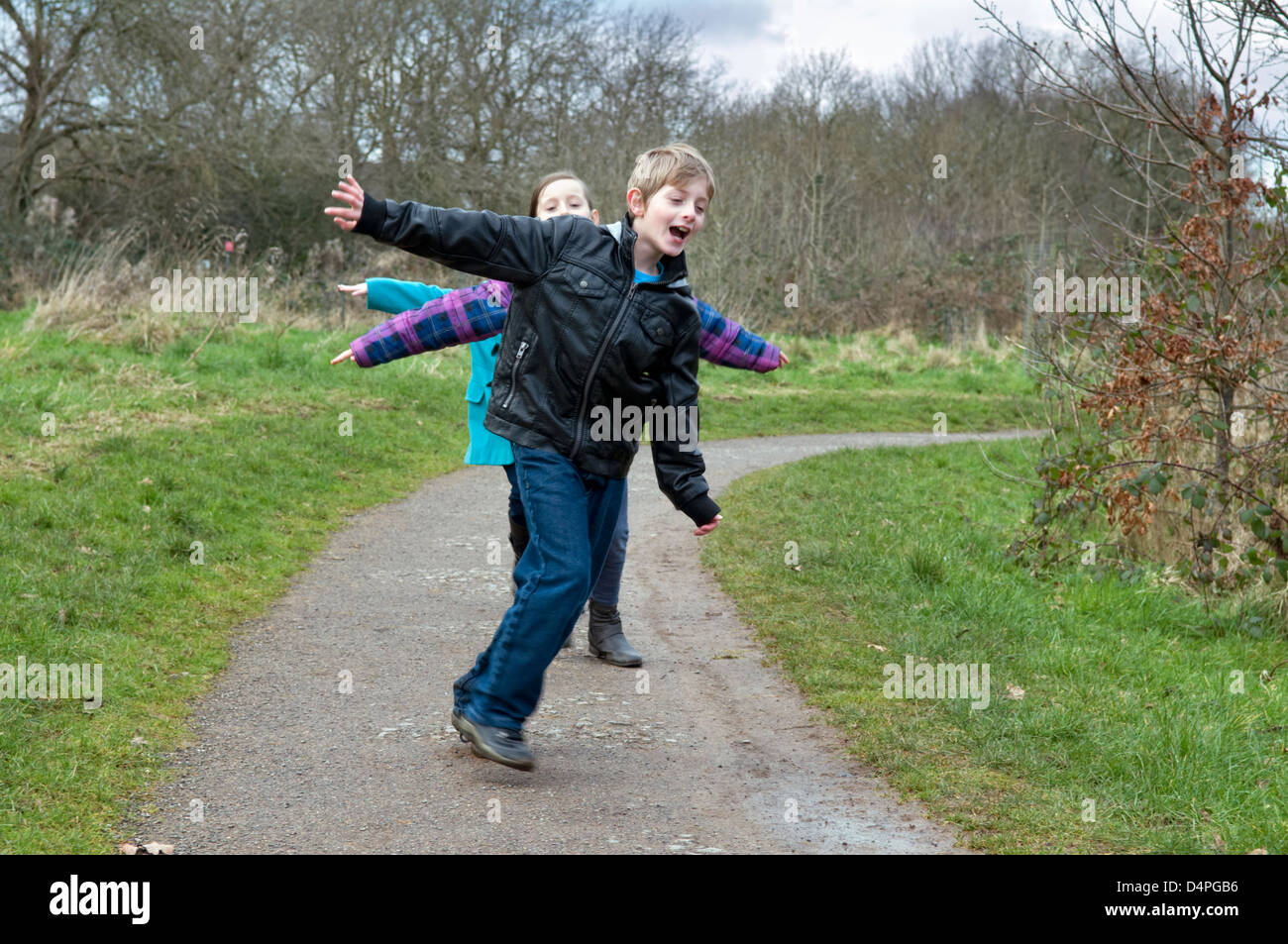 Children running making aeroplane (or airplane) shapes and having fun ...