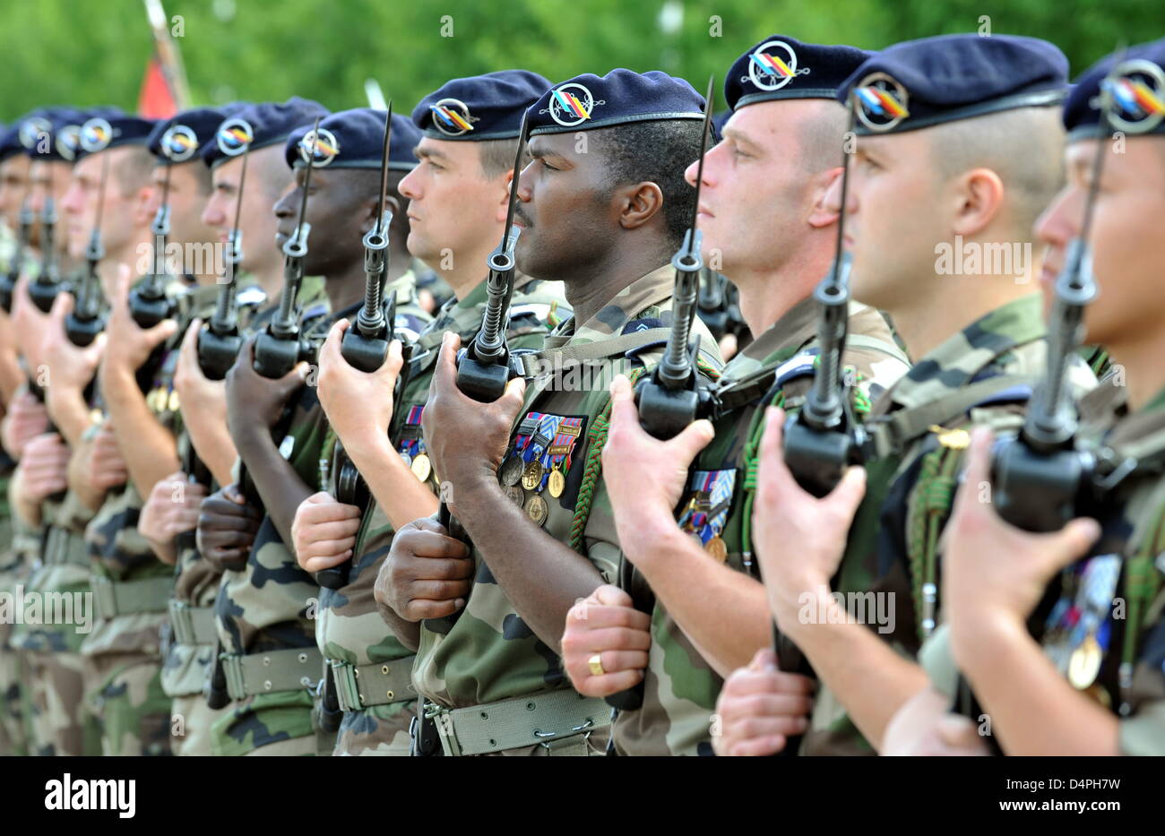 Soldiers of the Franco-German brigade stand still during a muster at ...