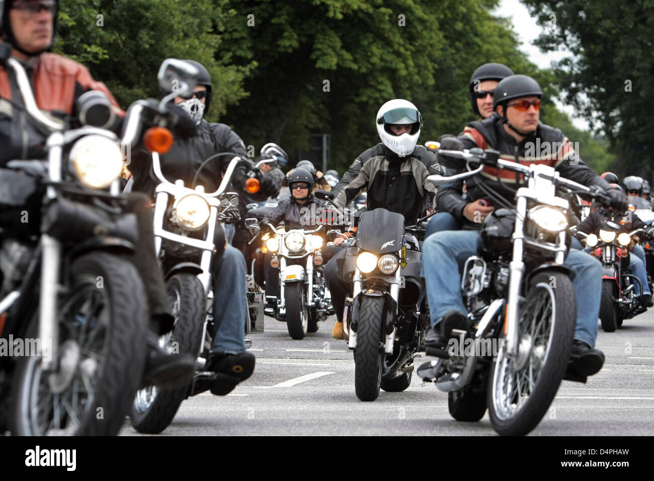 Participants of the motorcycle parade pass spectators during the ...