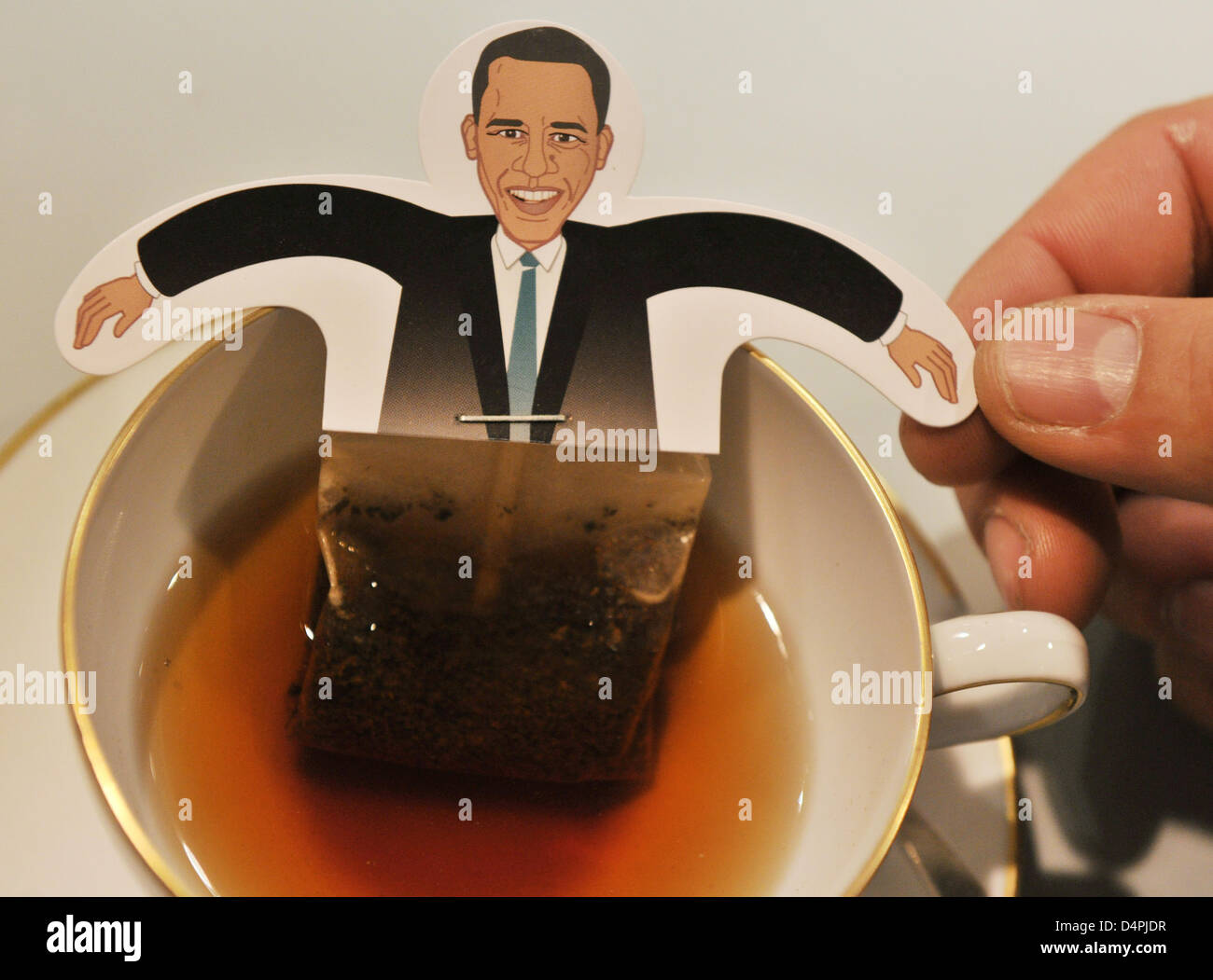 A tea bag mount designed after US President Barack Obama in a tea cup ...