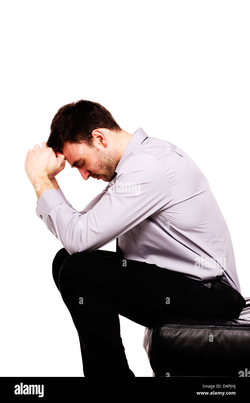 Business man upset sat with his head in his hands isolated on a white ...