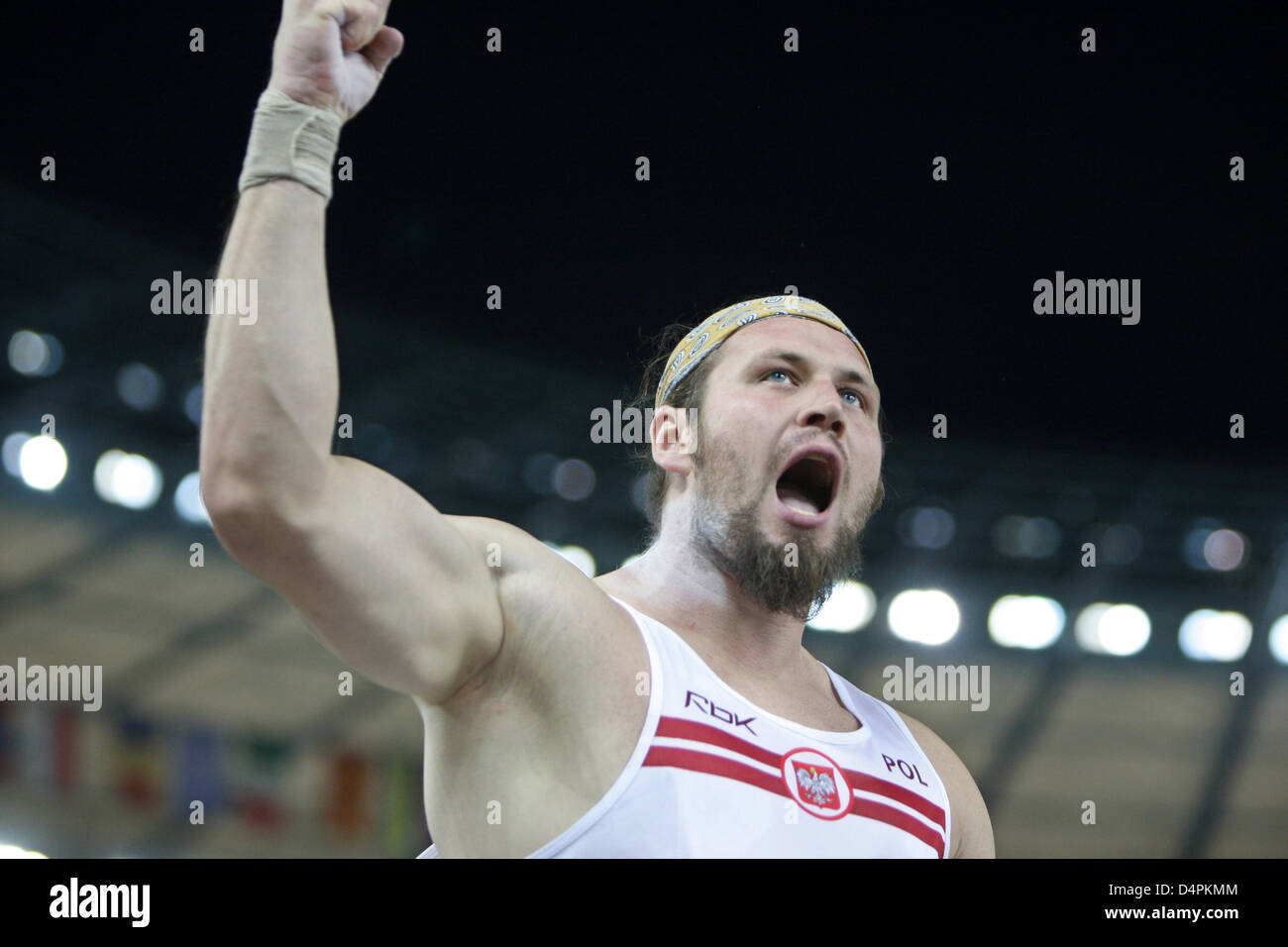 Polish Tomasz Majewski cheers after an attempt during the shot put ...