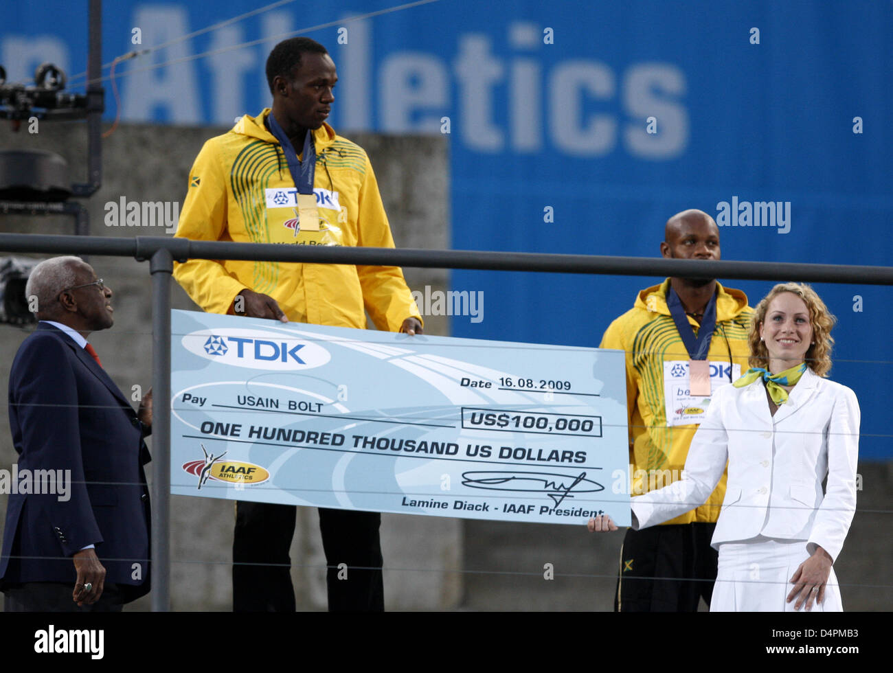 Jamaica?s Usain Bolt (2-L) receives the 100,000 dollar cheque after the ...