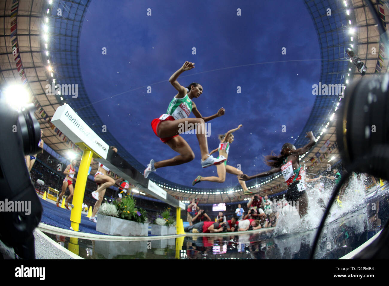 Runners clear the obstacle during the 3,000m Steeplechase final at the ...