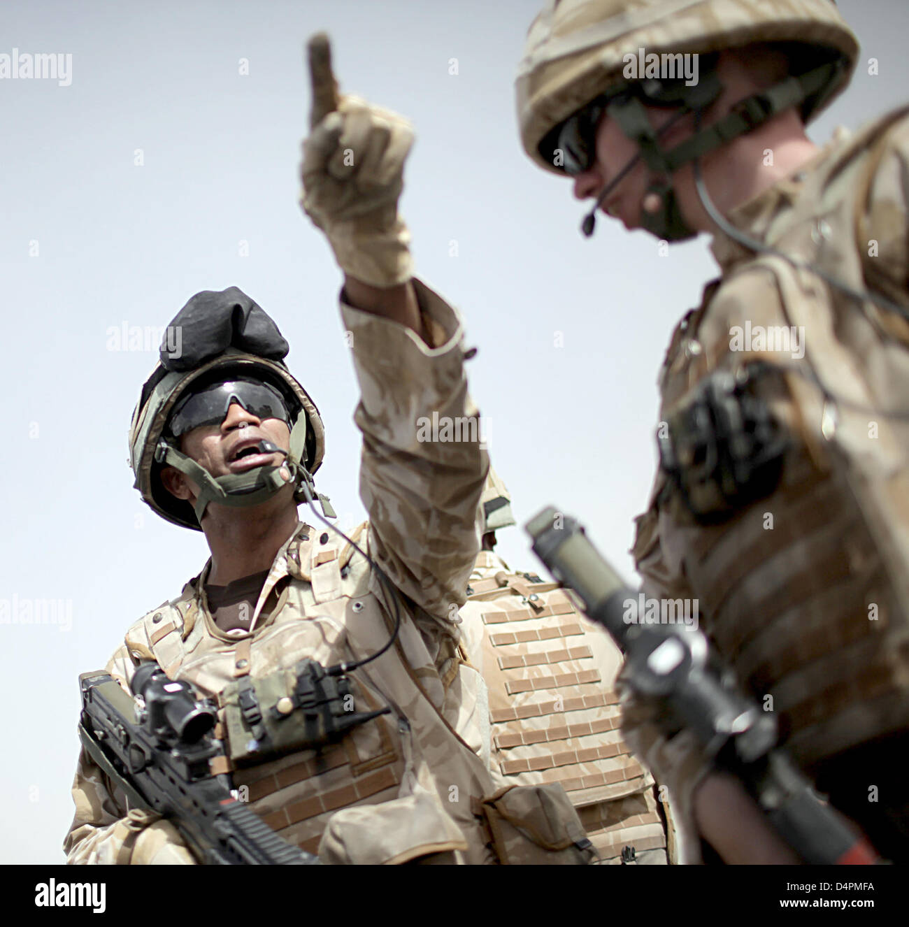 ISAF soldiers and Afghan police officers secure the scene of car bomb ...