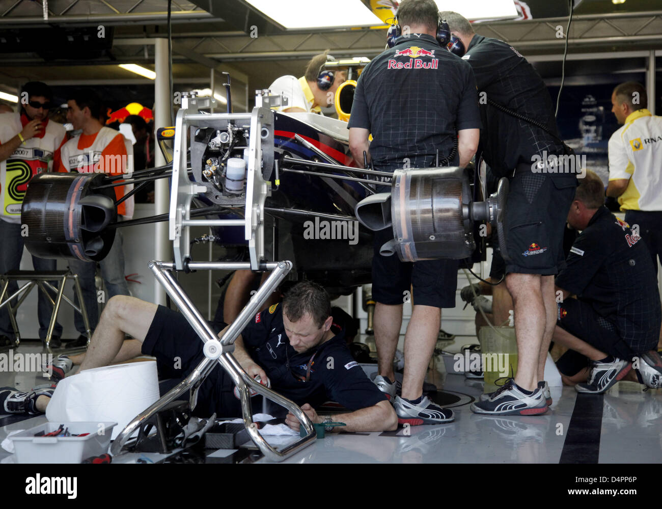 Engineers work at the car of German Formula One driver Sebastian Vettel ...
