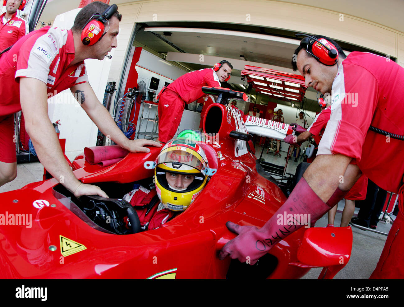Italian Formula One driver Luca Badoer of Scuderia Ferrari is pushed ...
