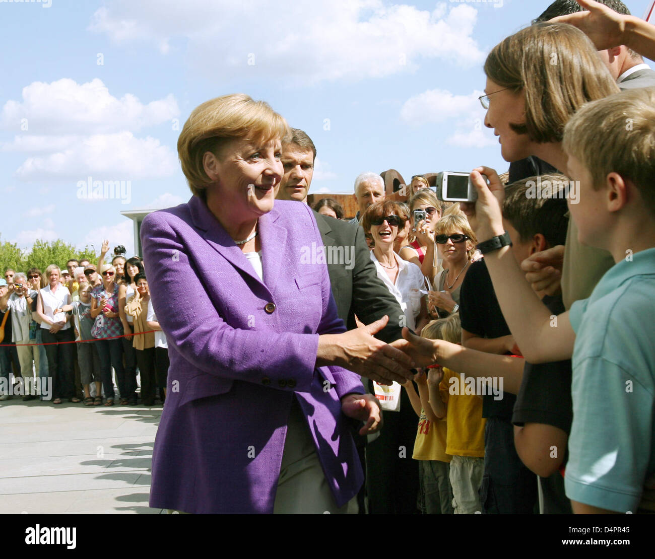 German Chancellor Angela Merkel welcomes visitors during the annual ...