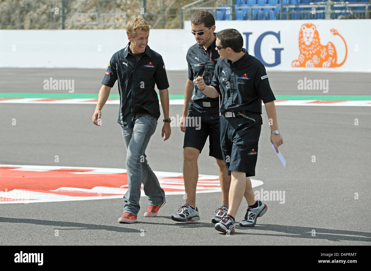 German Formula One driver Sebastian Vettel of Red Bull Racing (L) and ...