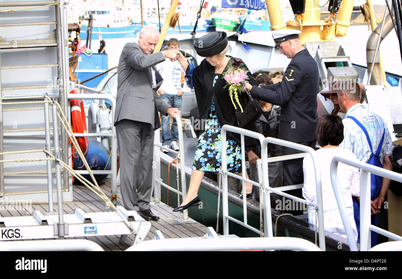 Queen Beatrix of the Netherlands steps onto a boat as she visits the ...