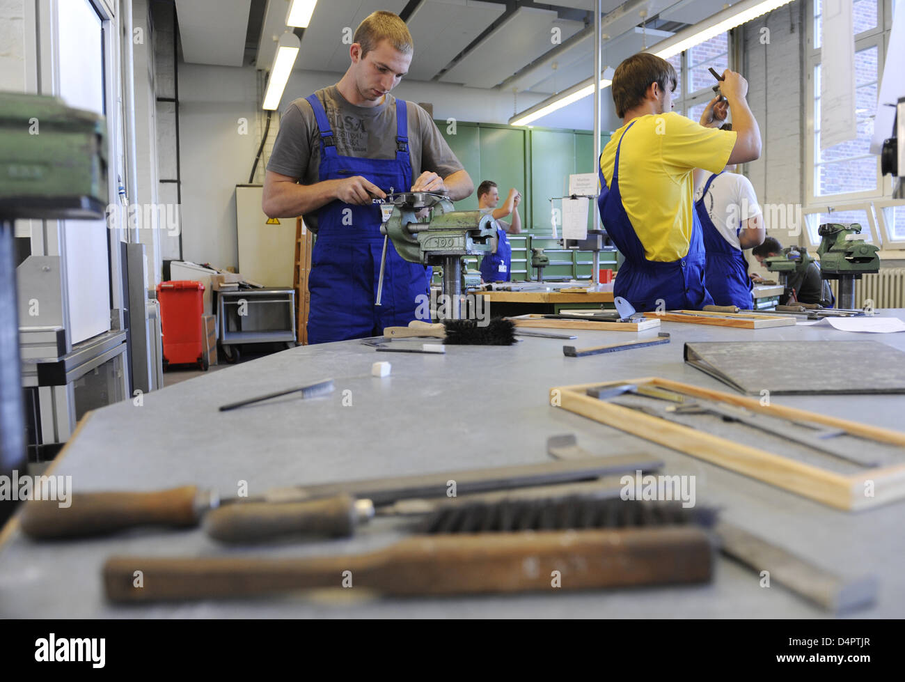 Apprentices of Siemens rasp metal parts as their training starts in ...
