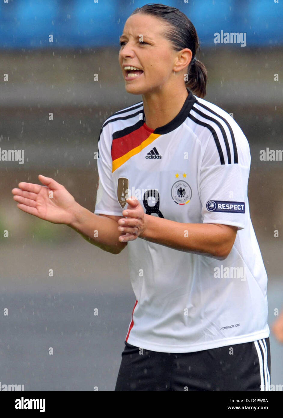 Germany?s scorer Inka Grings cheers her team mates on during the UEFA ...