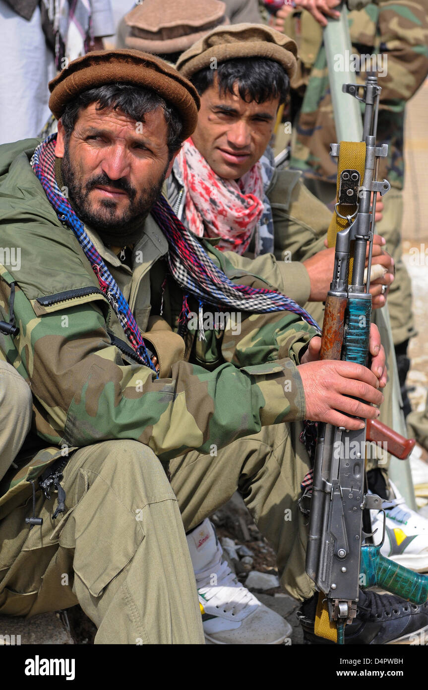 Afghan Local Police members dressed in traditional clothing listen to ...