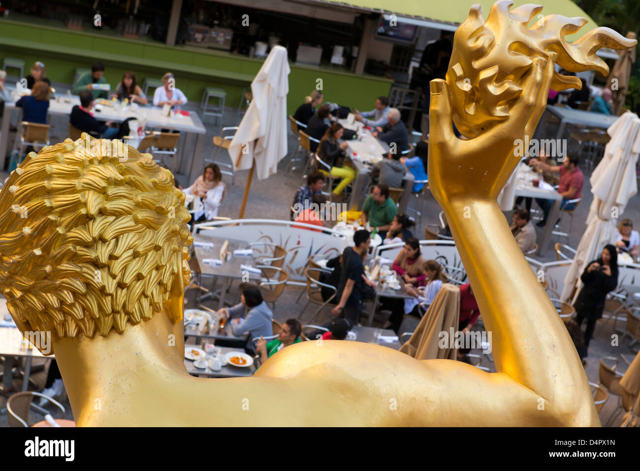 Prometheus statue from behind with diners at the Rockefeller Center ...