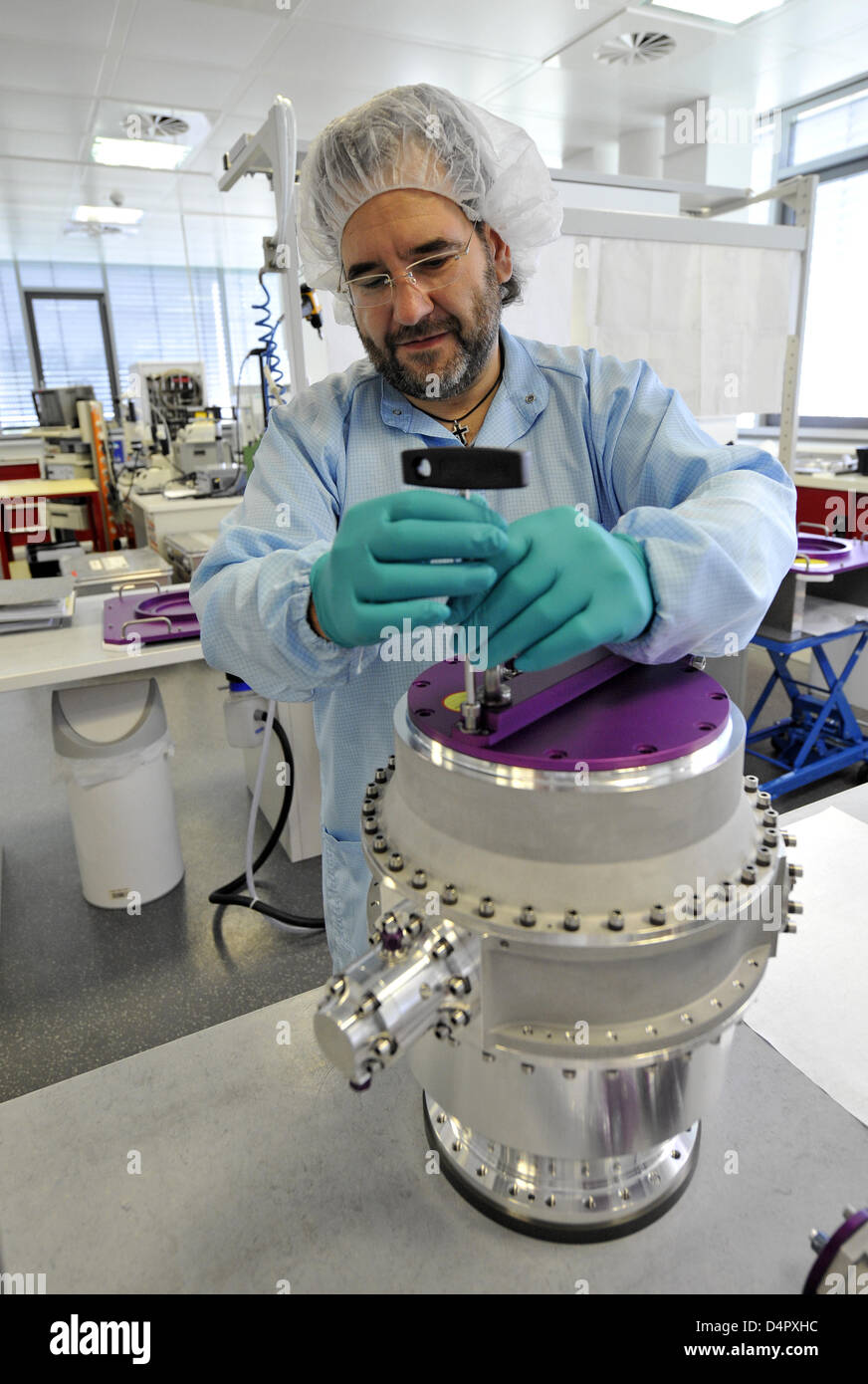 An employee of EADS Astrium checks a thrust chamber for ESA?s Ariane 5 ...