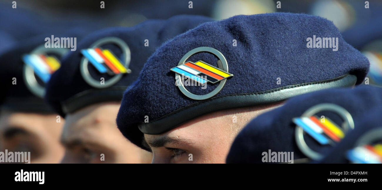 Soldiers of the German-French brigade wear caps with the brigade?s logo ...