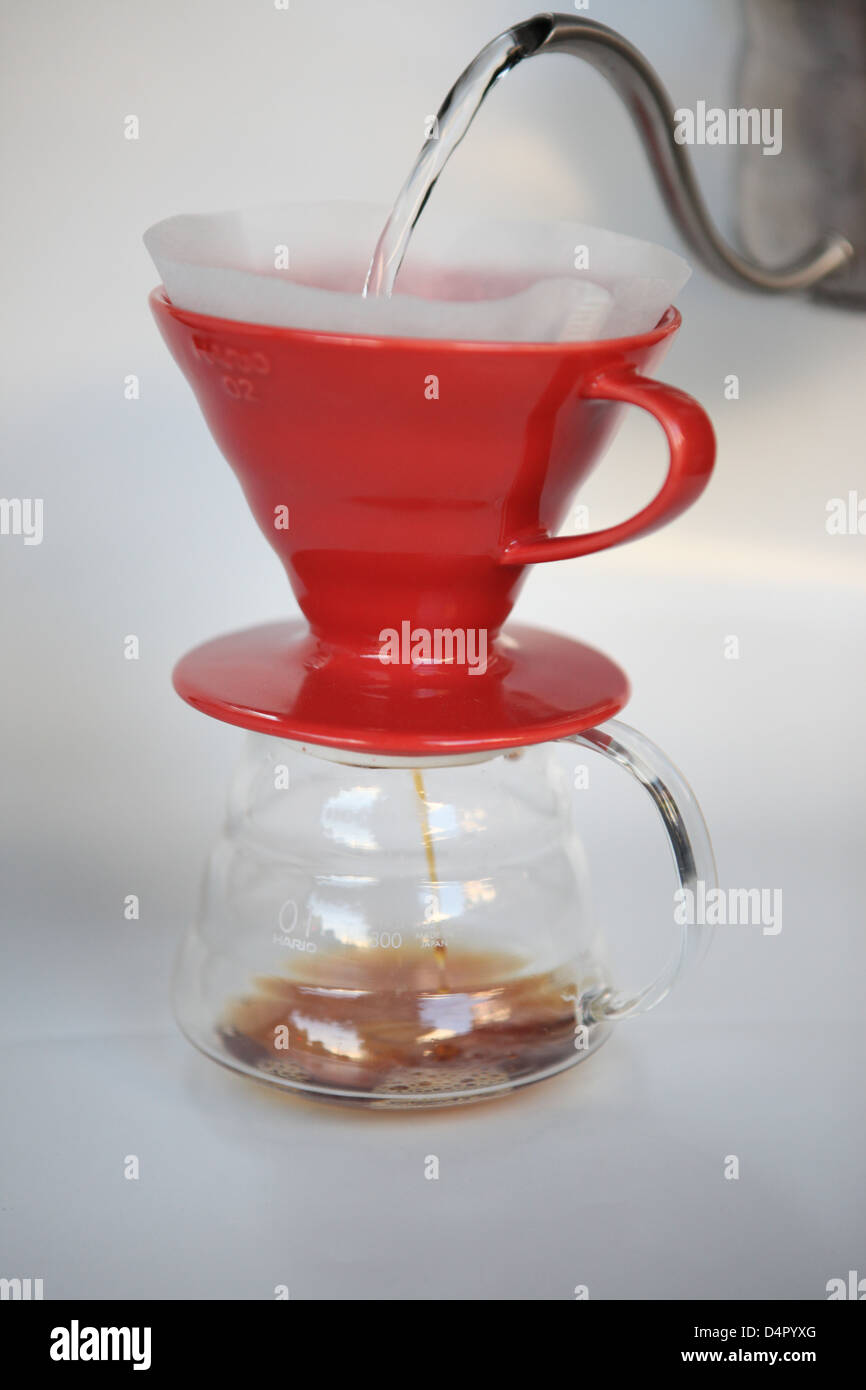 Filtering Coffee through paper filter Stock Photo - Alamy
