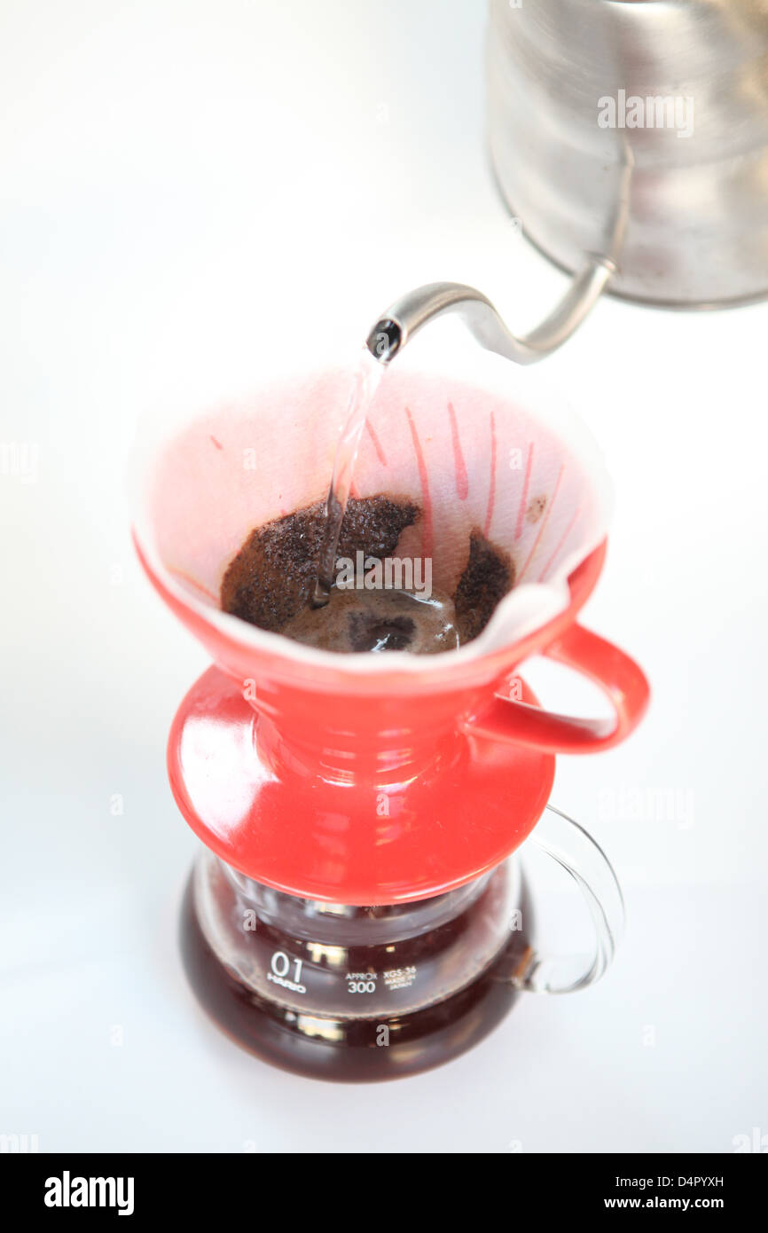 Filtering Coffee through paper filter Stock Photo - Alamy