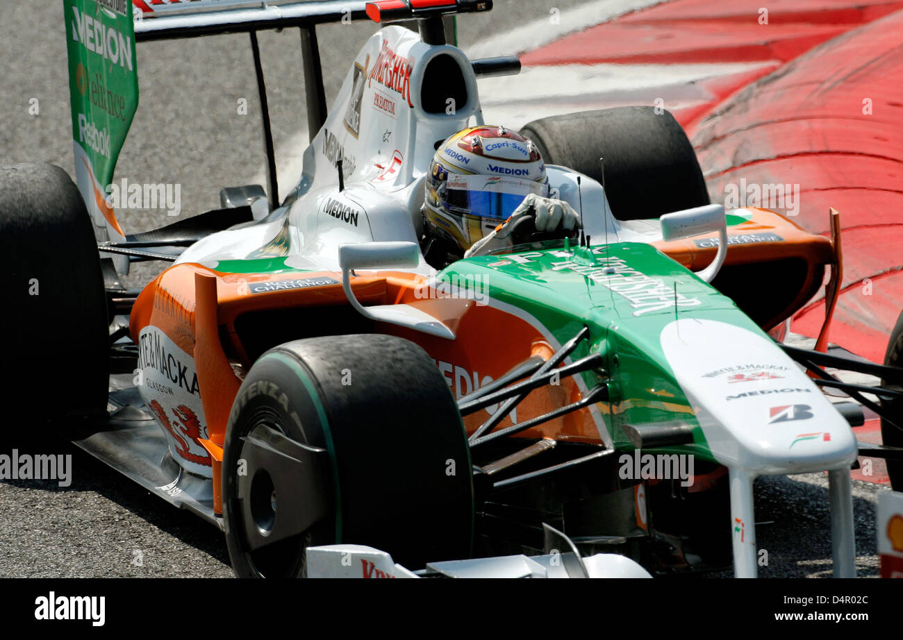 German Adrian Sutil of Force India races his car in the first turn ...