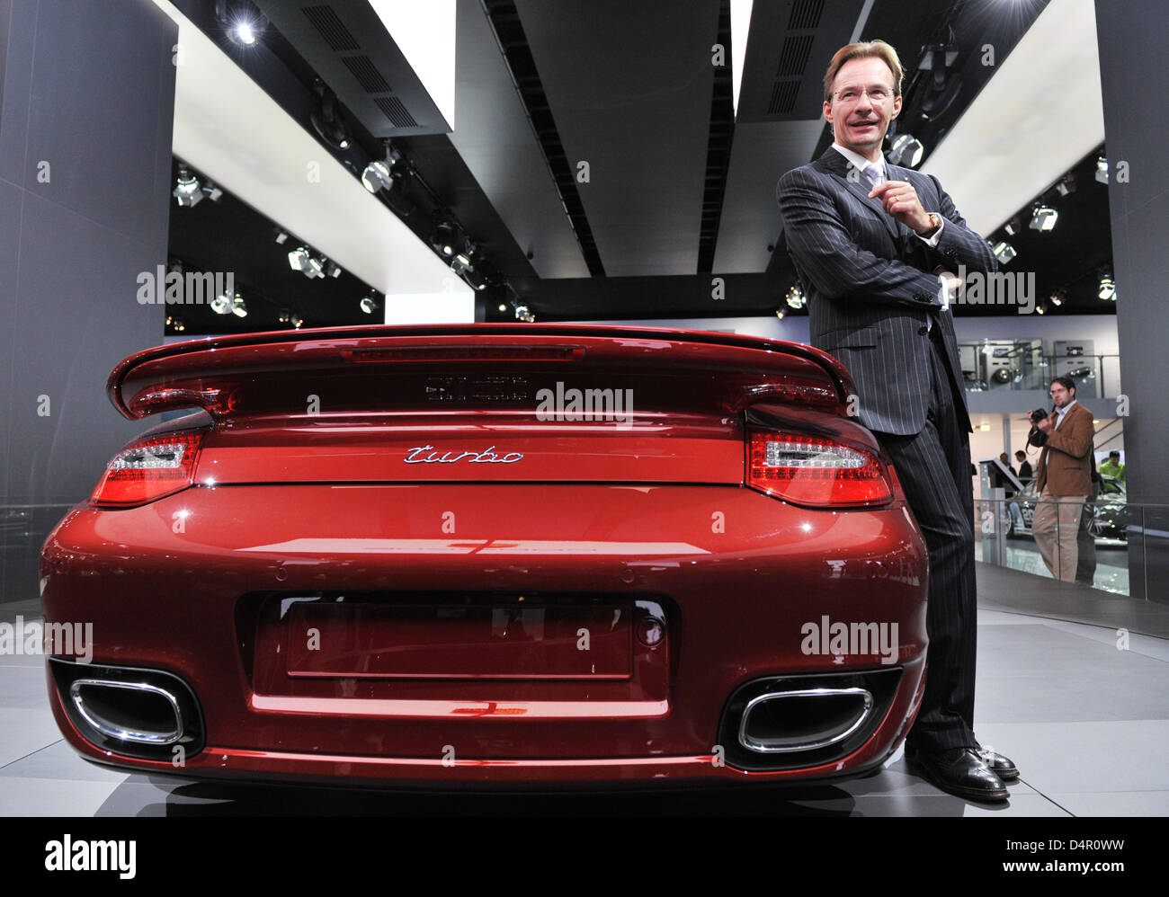 Porsche CEO Michael Macht poses with a Porsche ahead of the upcoming ...