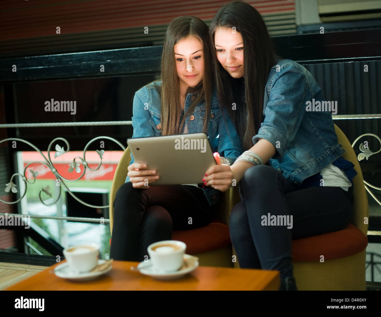 Two cute girls using cell hi-res stock photography and images - Alamy