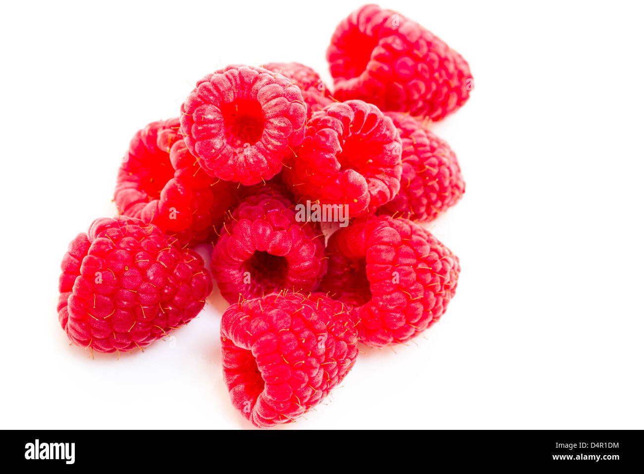 Heap of organic raspberries on white background Stock Photo - Alamy