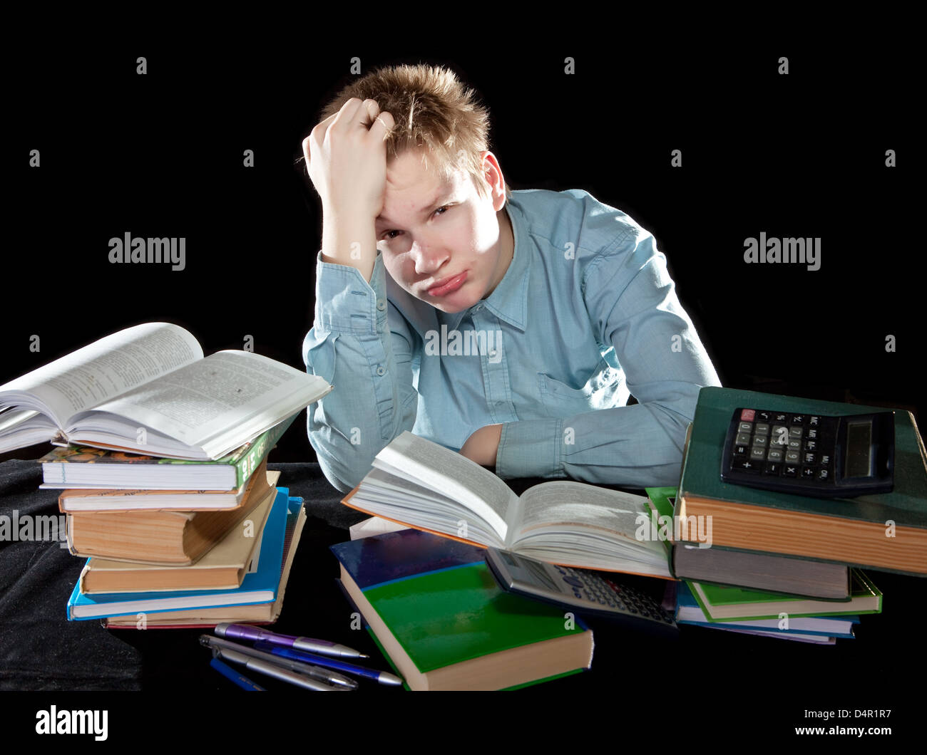 The teenager with a heap of textbooks. Was tired of homework Stock ...