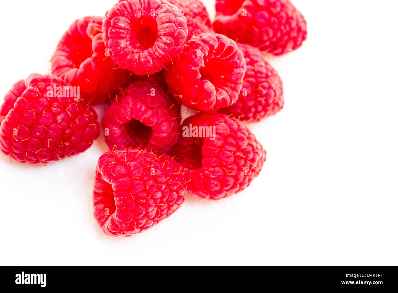 Heap of organic raspberries on white background Stock Photo - Alamy