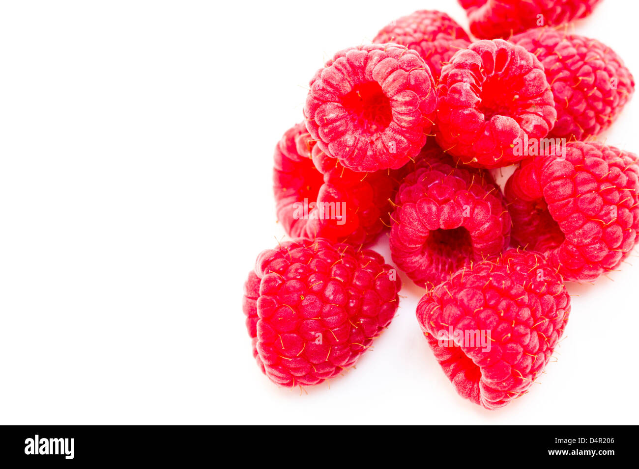 Heap of organic raspberries on white background Stock Photo - Alamy