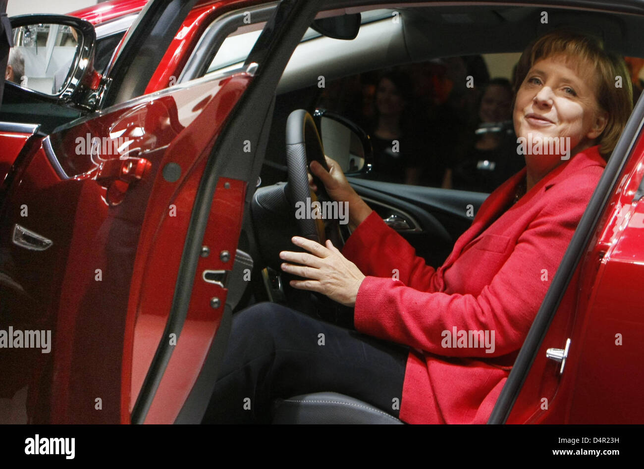 German Chancellor Angela Merkel smiles in Opel?s new Astra as she ...