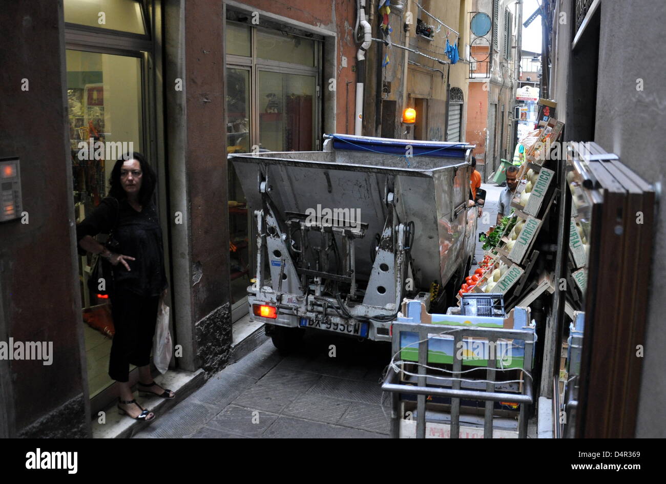 Waste disposal in a narrow alley in the old quarters of Genoa, Italy ...