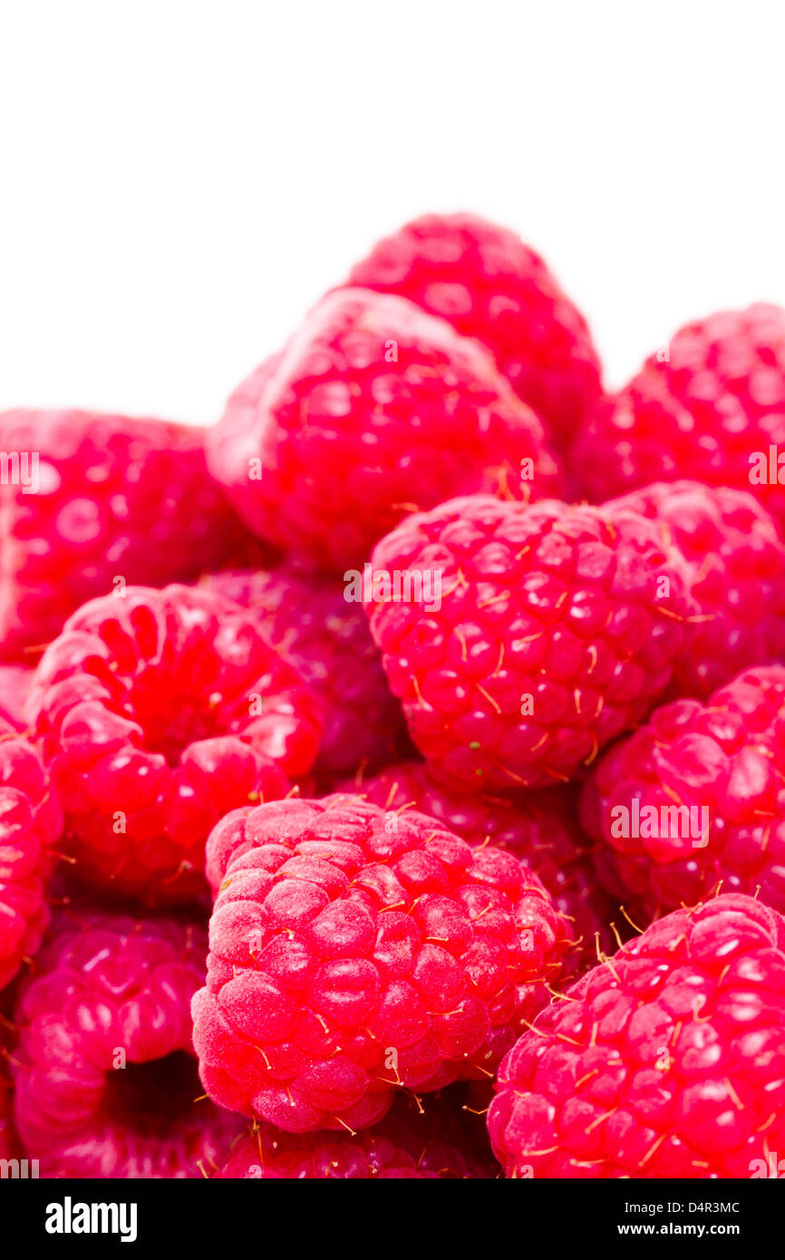 Heap of organic raspberries on white background Stock Photo - Alamy