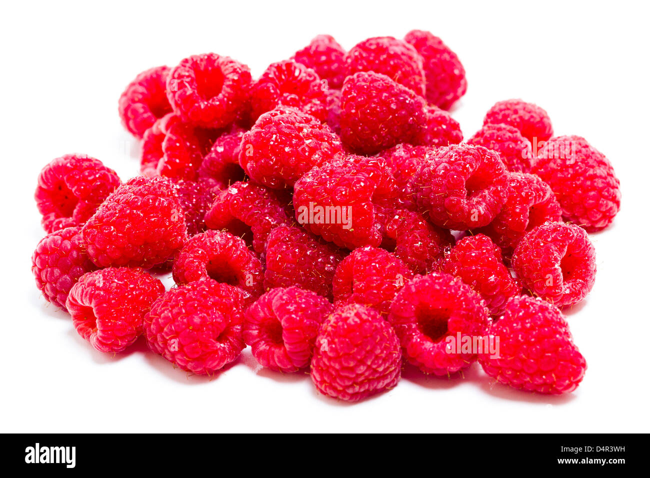 Heap of organic raspberries on white background Stock Photo - Alamy