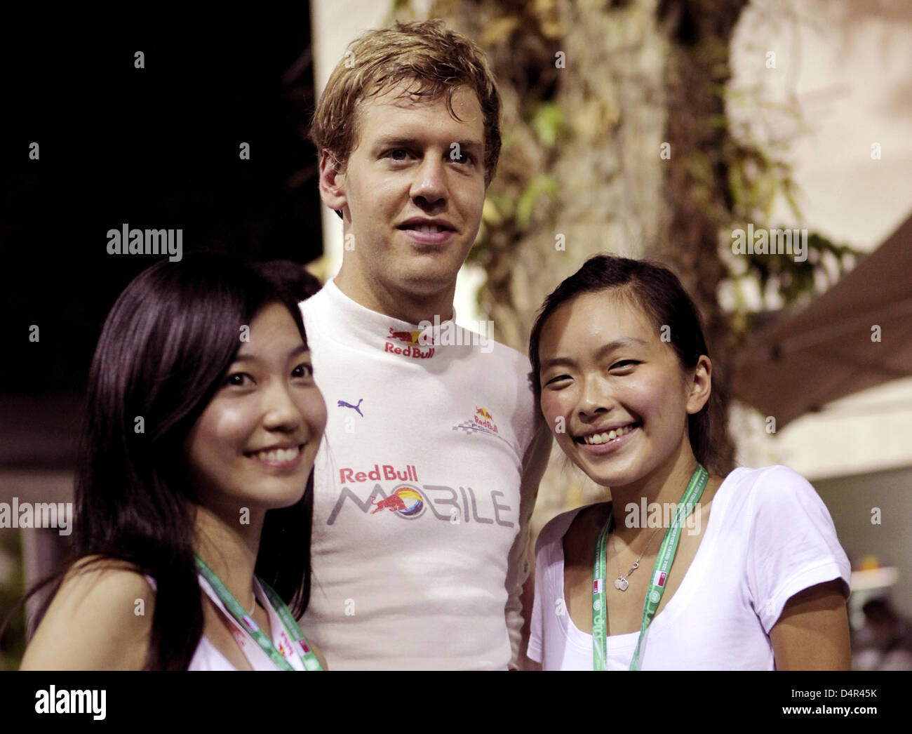 German Formula One driver Sebastian Vettel of Red Bull Racing (C) poses ...