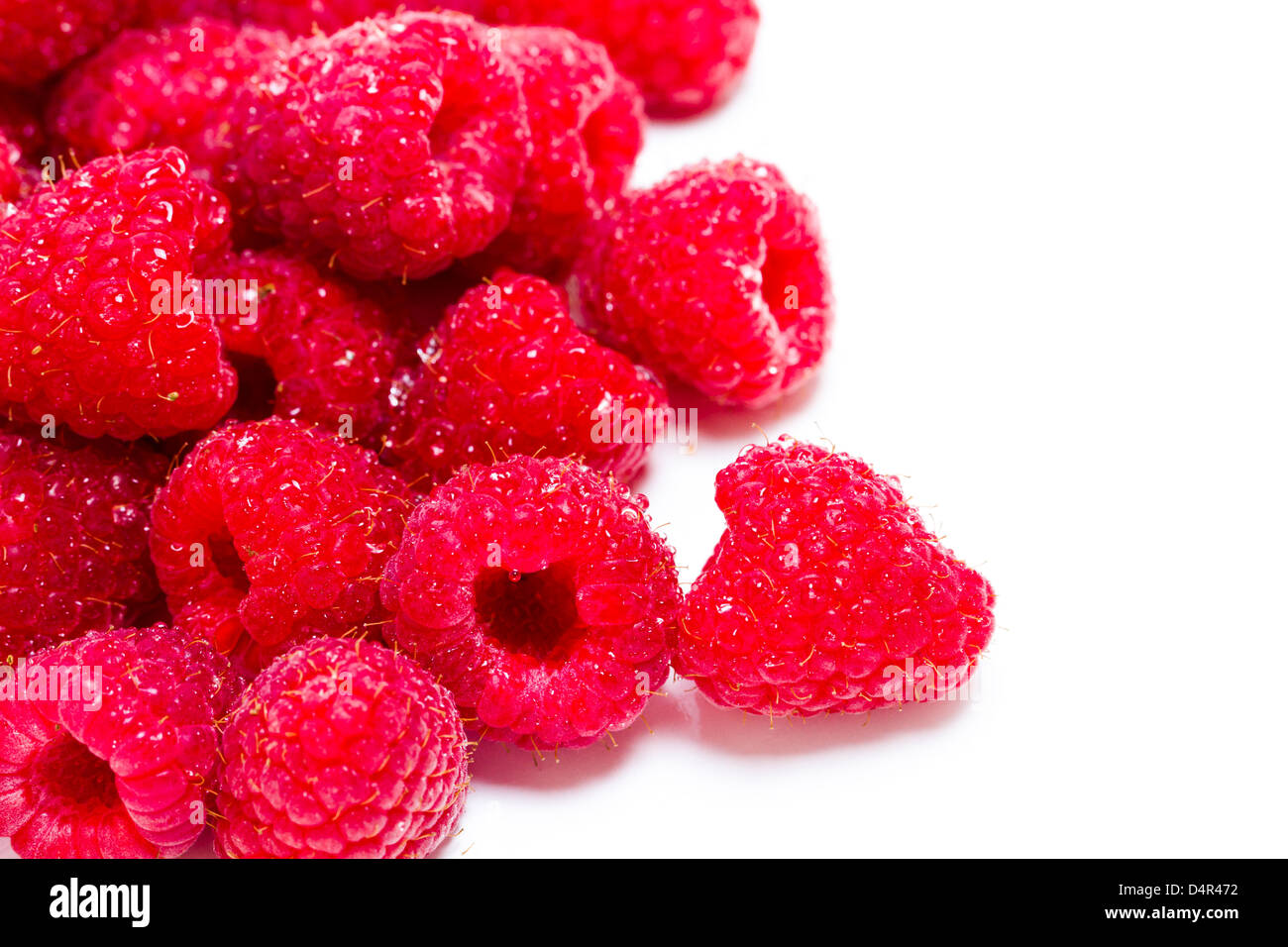 Heap of organic raspberries on white background Stock Photo - Alamy