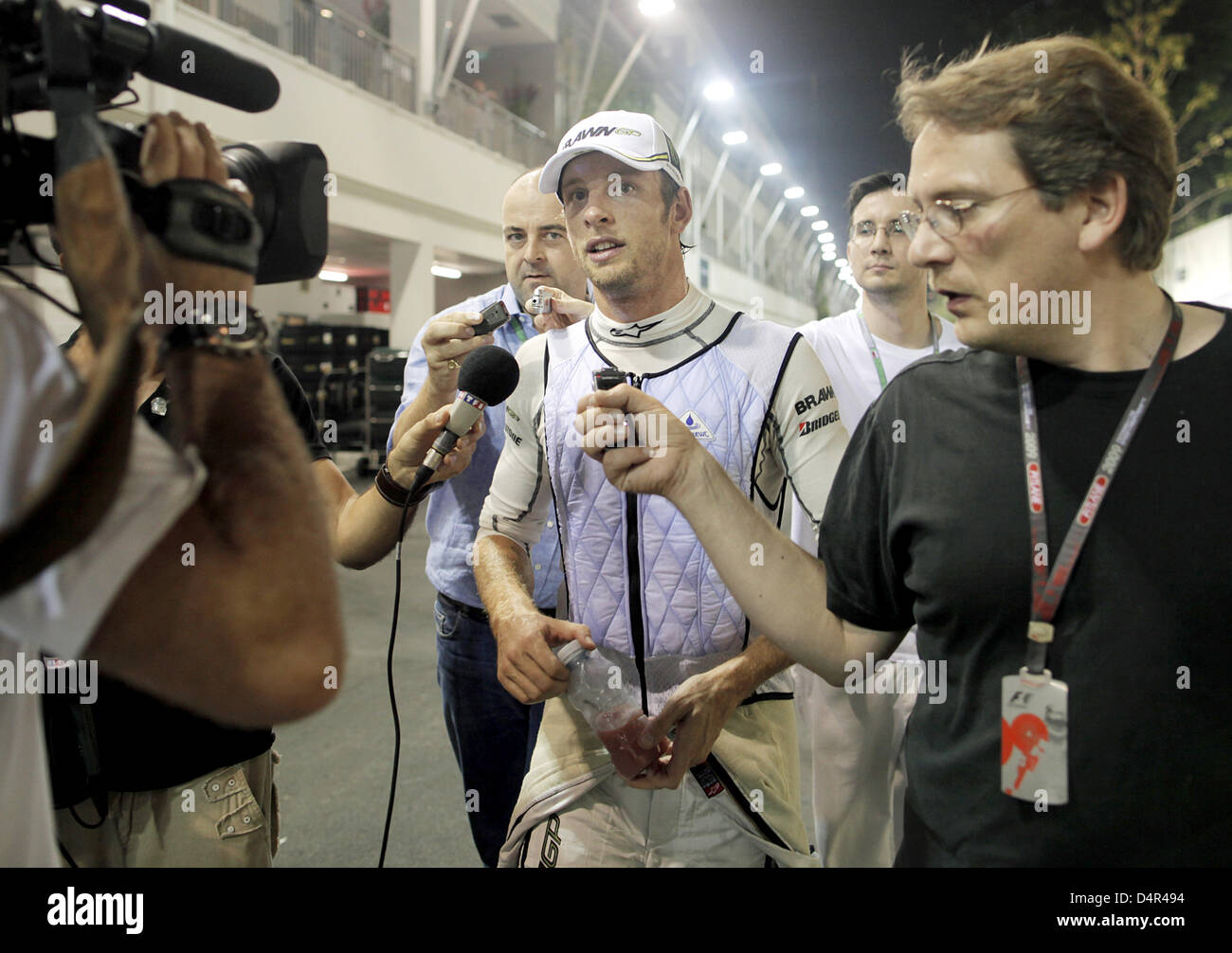 British Formula One driver Jenson Button of Brawn GP (C) talks to ...