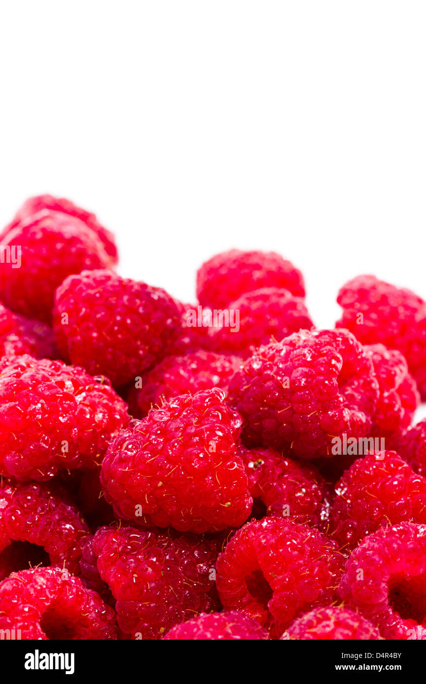 Heap of organic raspberries on white background Stock Photo - Alamy