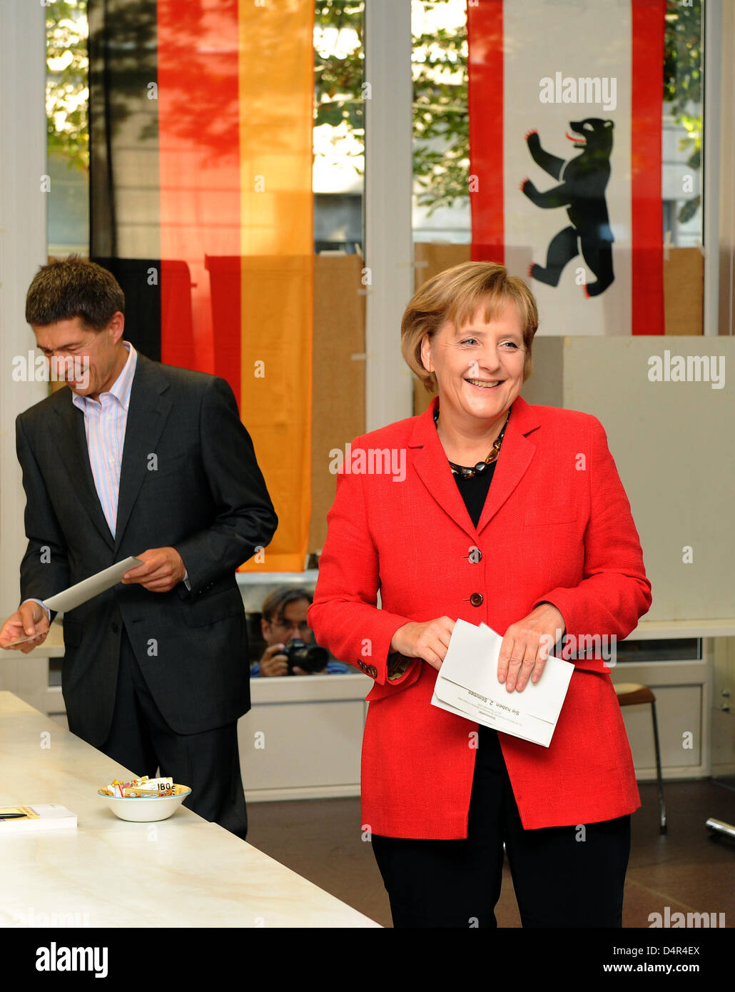 German Chancellor Angela Merkel (R) and her husband Joachim Sauer (L ...