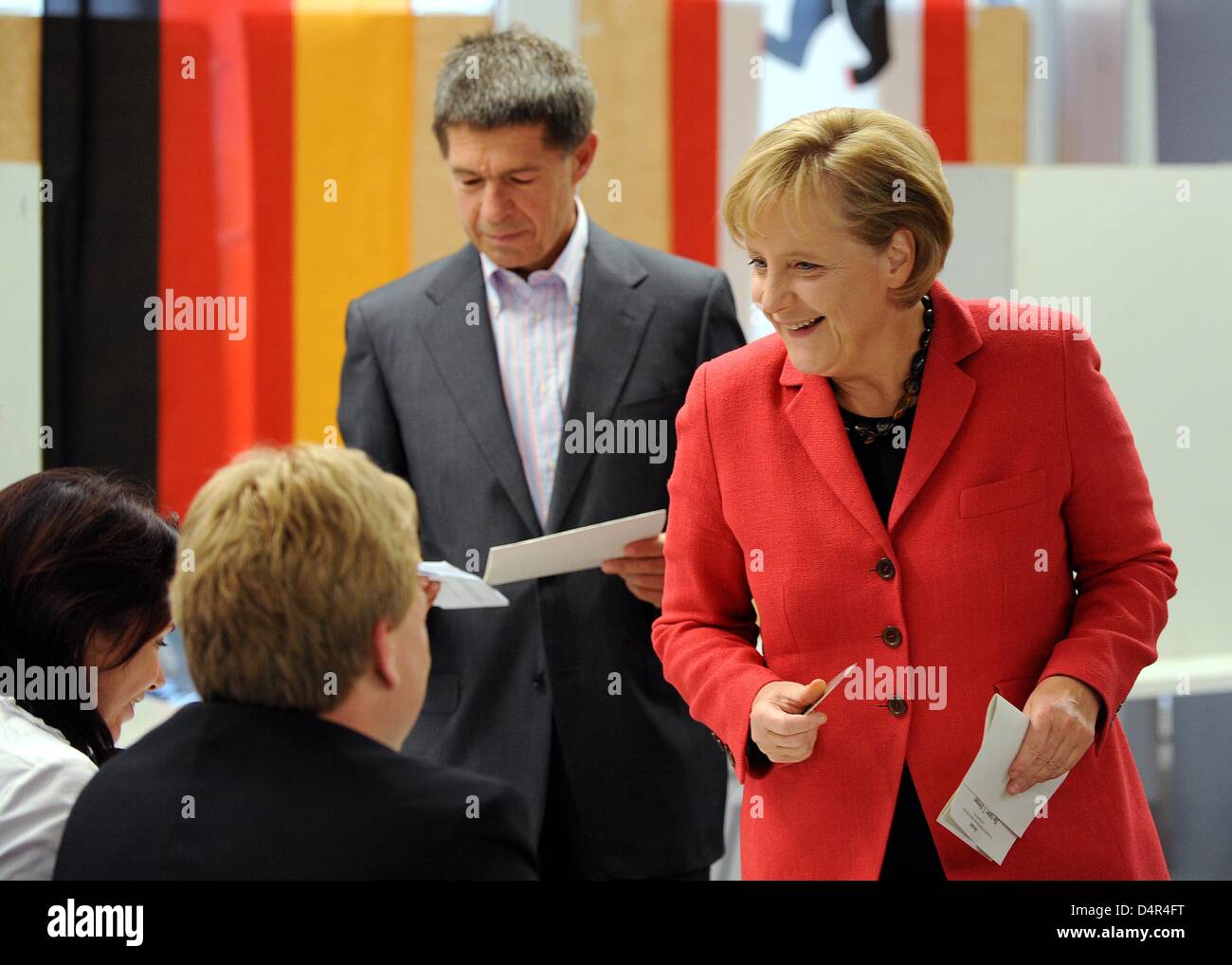German Chancellor Angela Merkel (R) and her husband Joachim Sauer (L ...