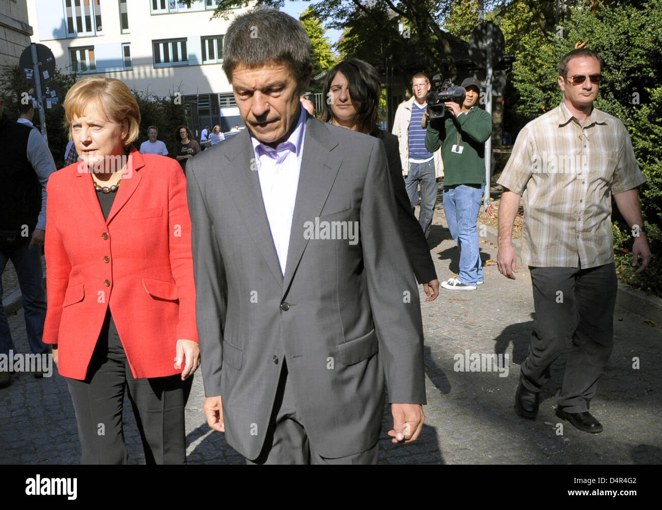 German Chancellor Angela Merkel (L) and her husband Joachim Sauer (R ...