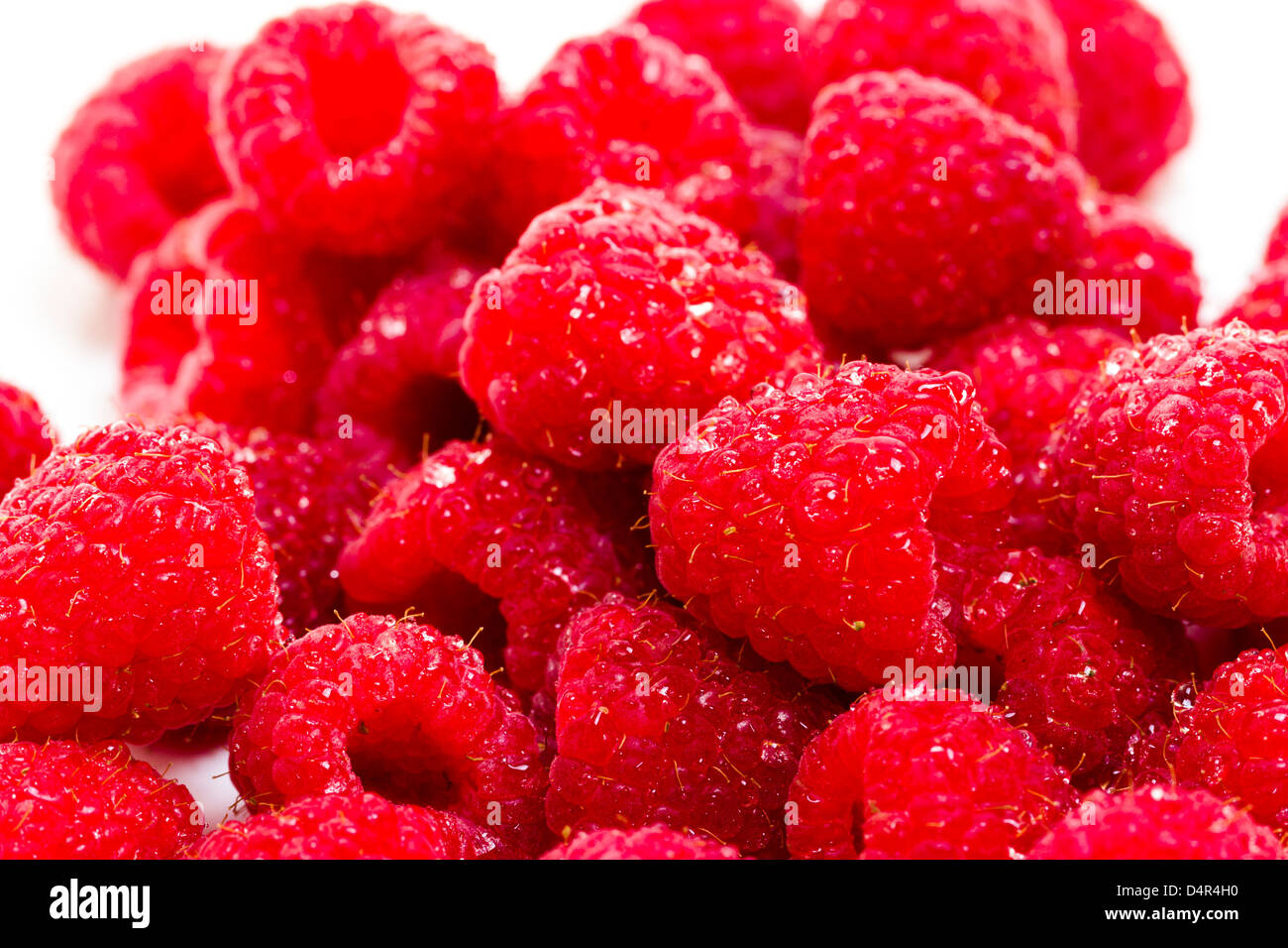 Heap of organic raspberries on white background Stock Photo - Alamy