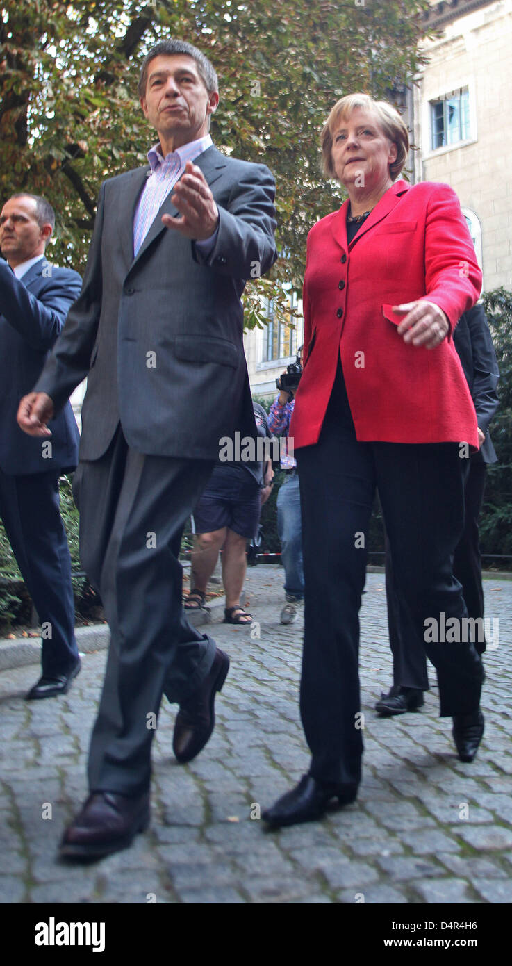 German Chancellor Angela Merkel (R) and her husband Joachim Sauer (L ...