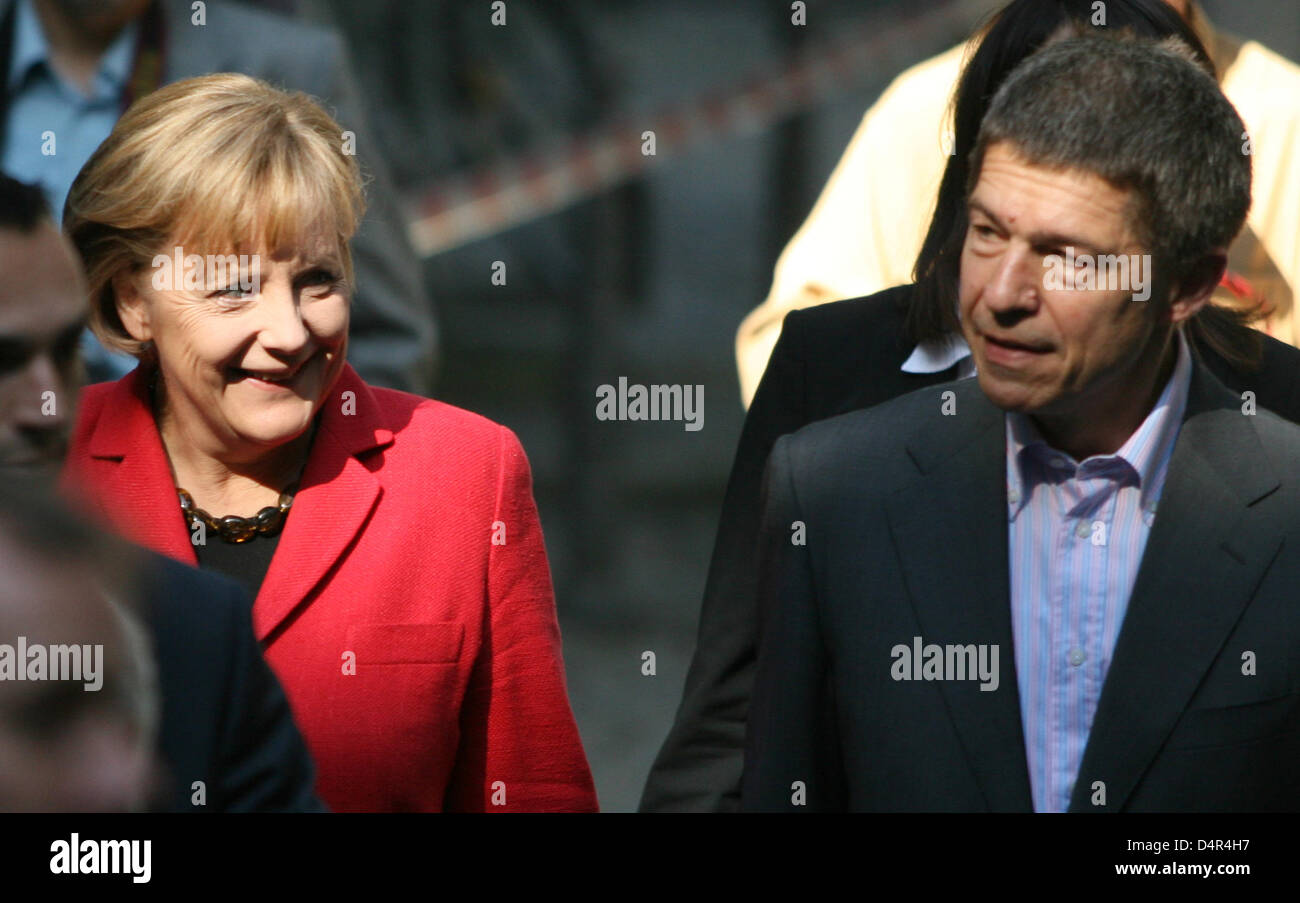 German Chancellor Angela Merkel (L) and her husband Joachim Sauer (R ...