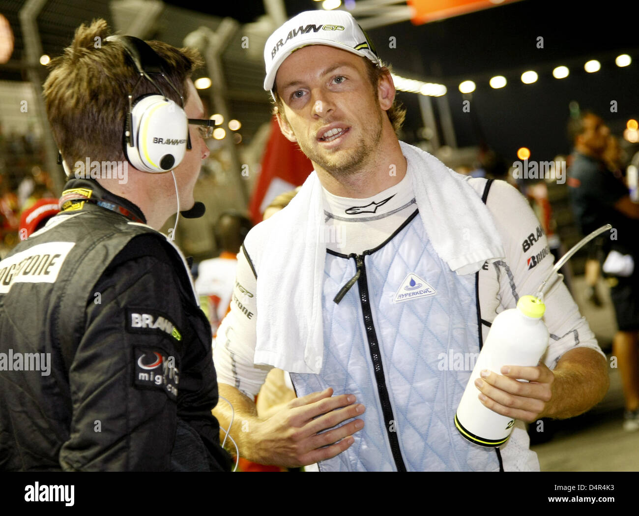 British Formula One driver Jenson Button of Brawn GP (R) gestures in ...