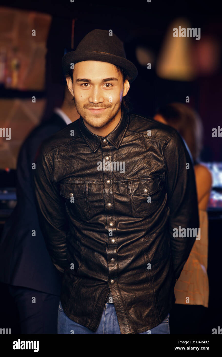 Handsome young man wearing hat smiling for the camera Stock Photo - Alamy