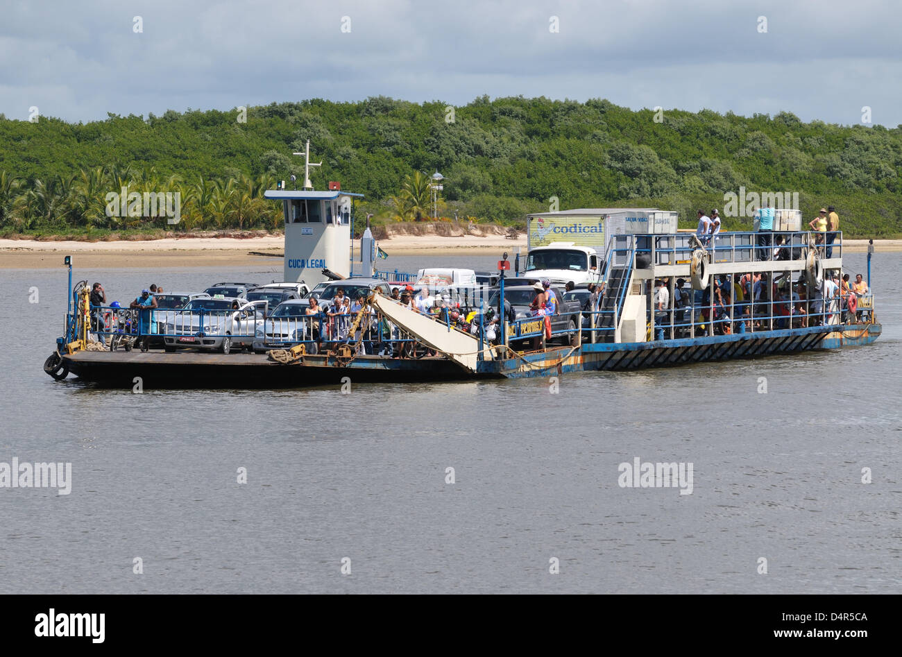 A ferry transports people over Bunharem river in Porto Seguro, BA ...