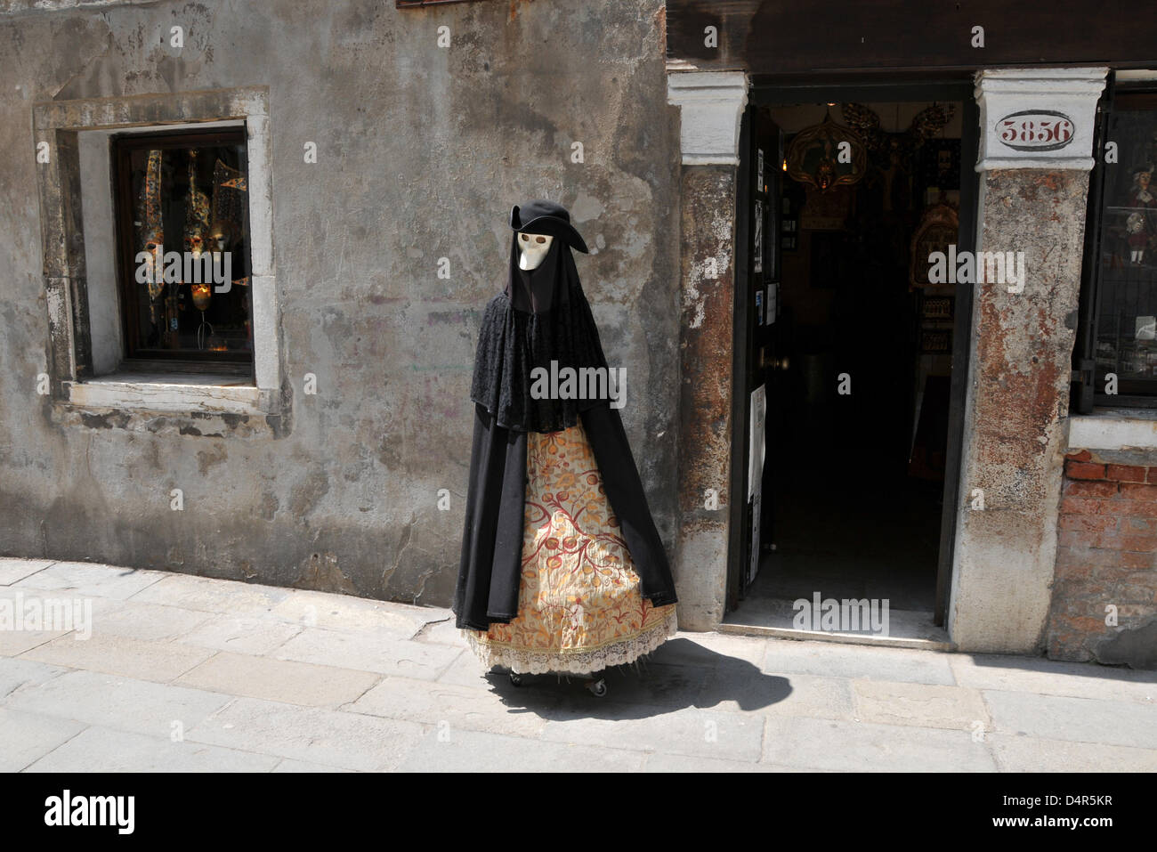 A masked puppet, dressed in a black cloack with matching hat, promotes ...